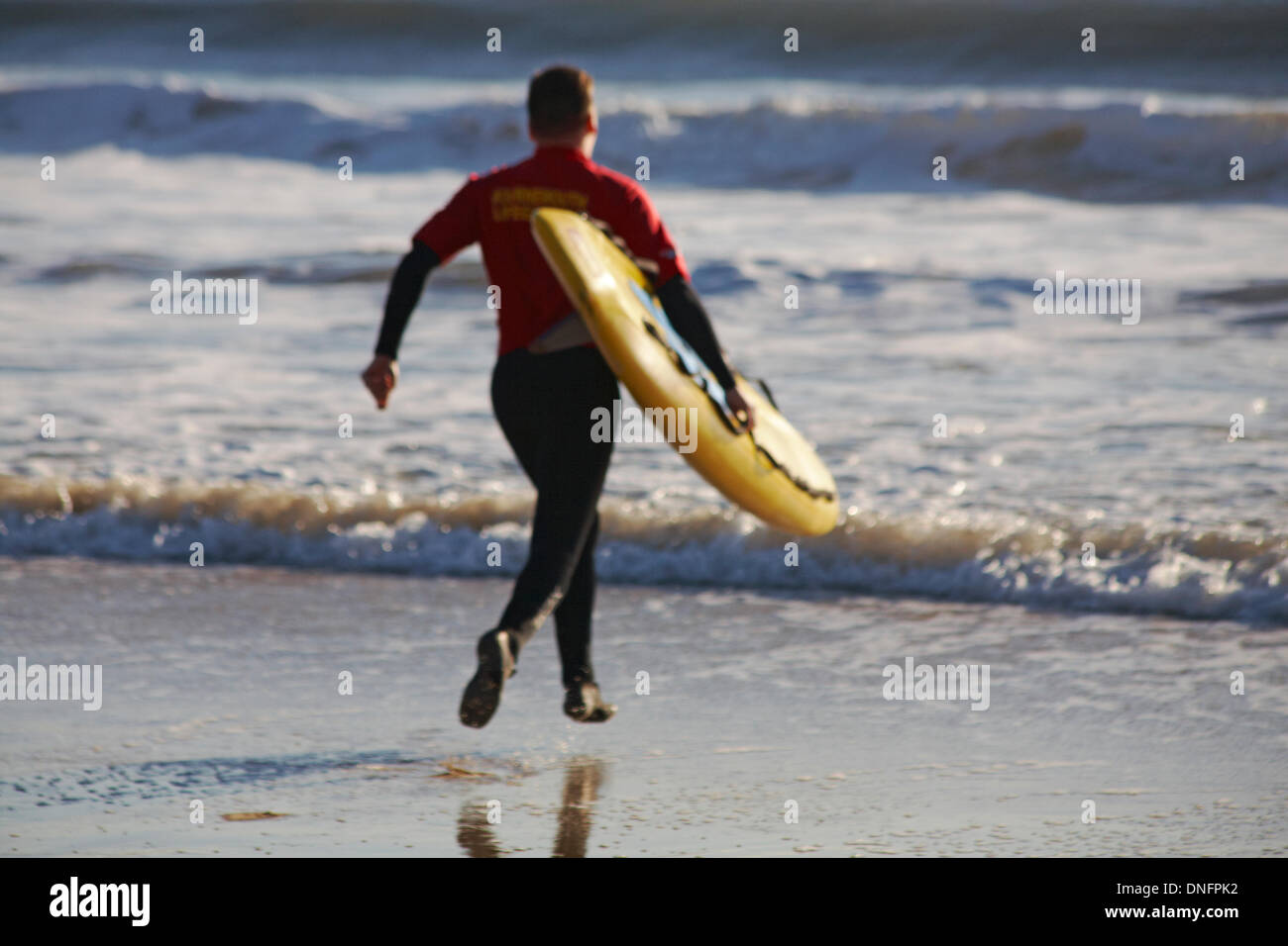 Rnli lifeguard carrying surf board hi-res stock photography and images ...