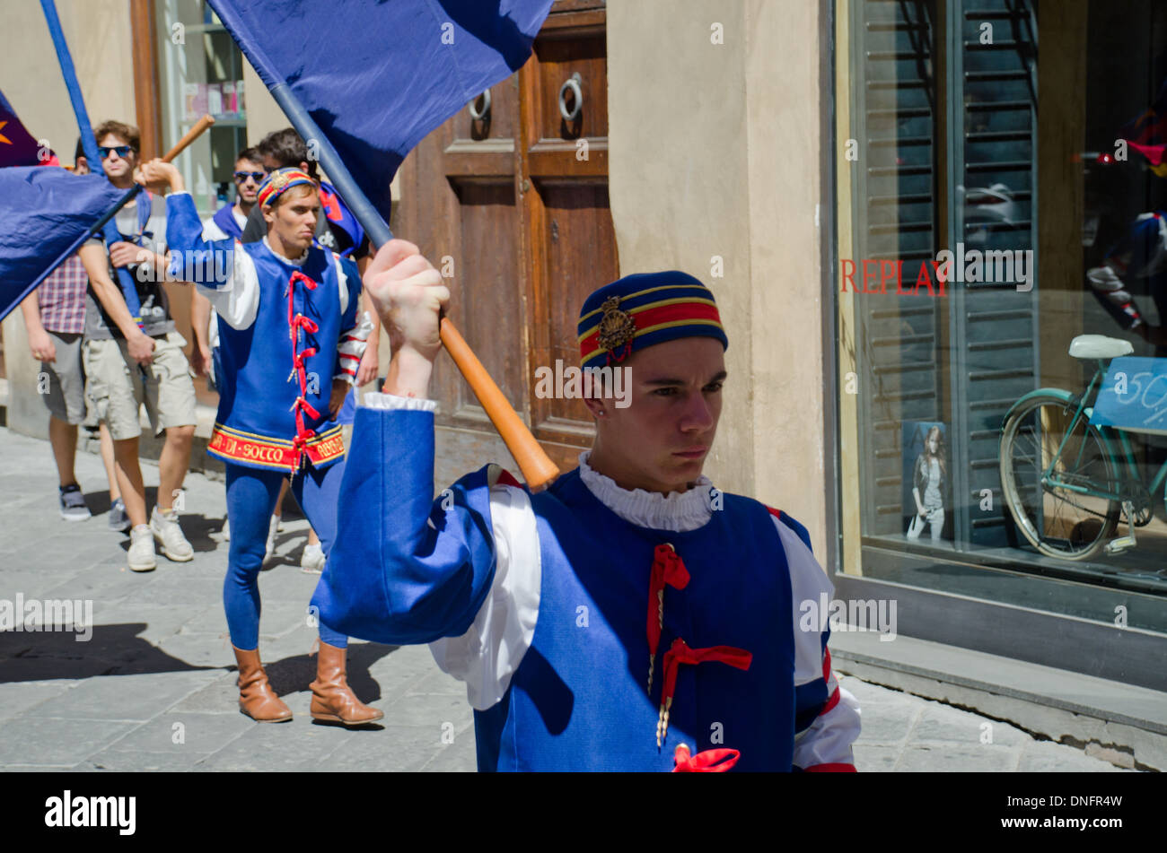 young bannerman waving flag, Italian parade (parata) in Siena, Toscana ...
