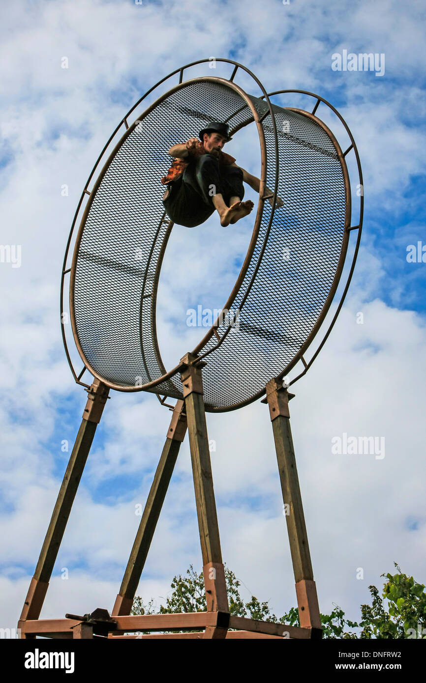 Circus performer entertaining the public with his hamster wheel Stock ...