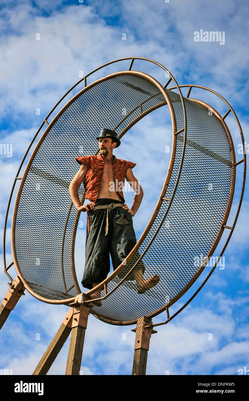 Circus performer entertaining the public with his hamster wheel Stock ...