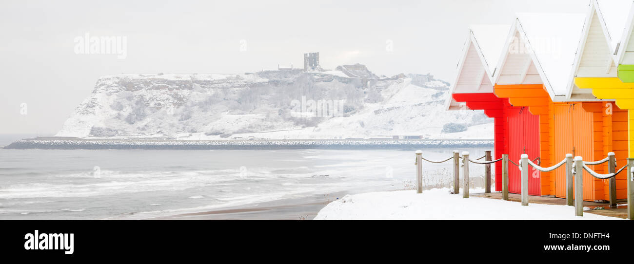 Colourful beach huts in the north bay Scarborough, under heavy snow in ...
