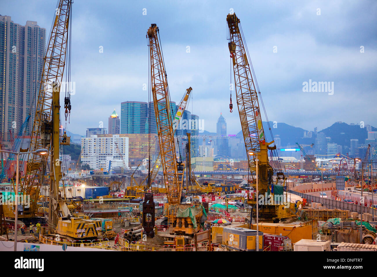 Construction site with parked cranes, at down in Hong Kong China Stock ...