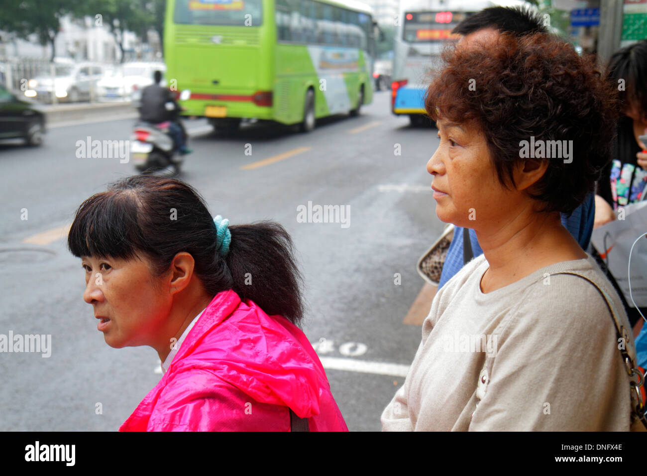 Chinese woman waiting bus stop hi-res stock photography and images - Alamy