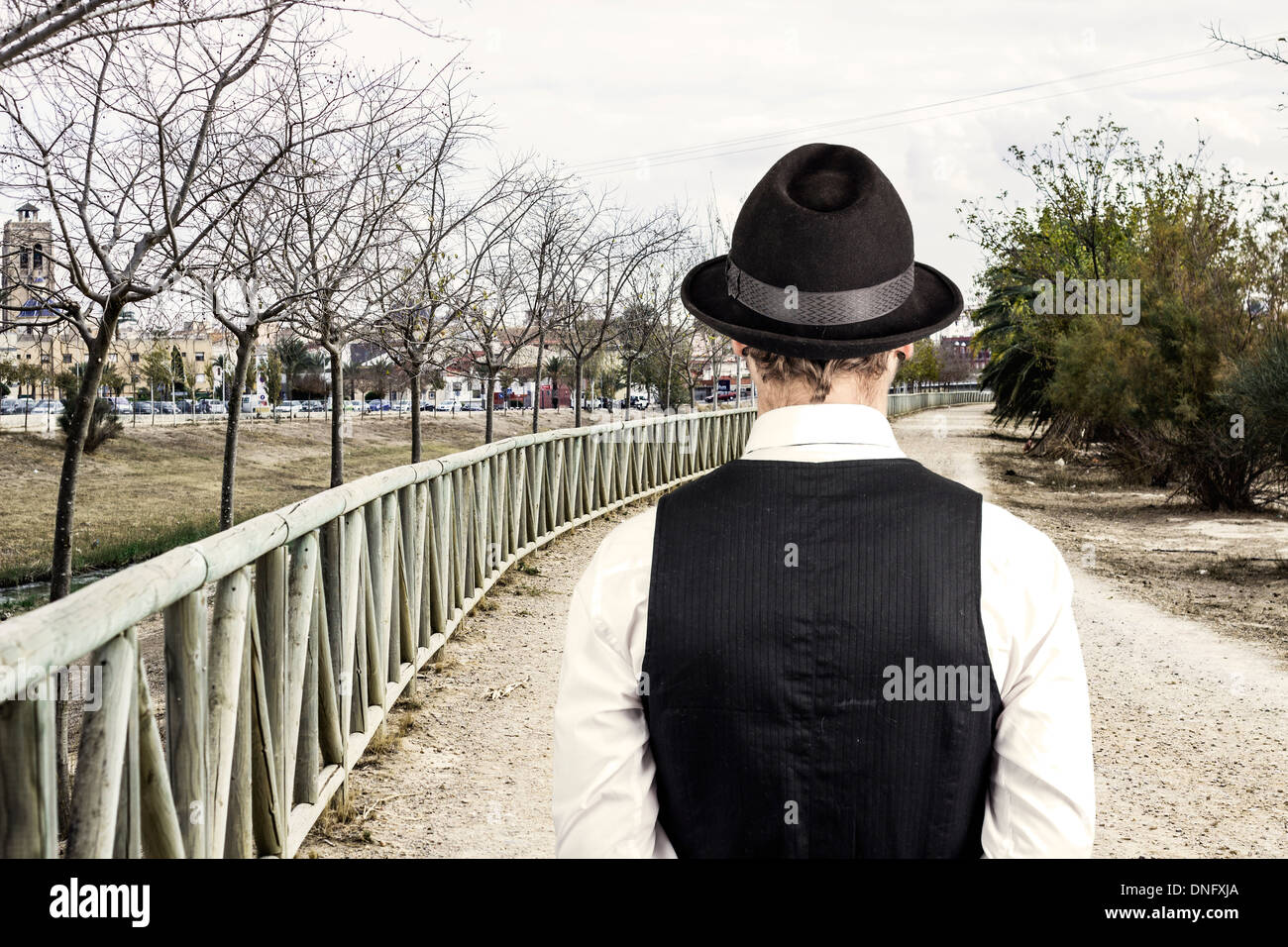 Guy walking on street with black hat Stock Photo - Alamy