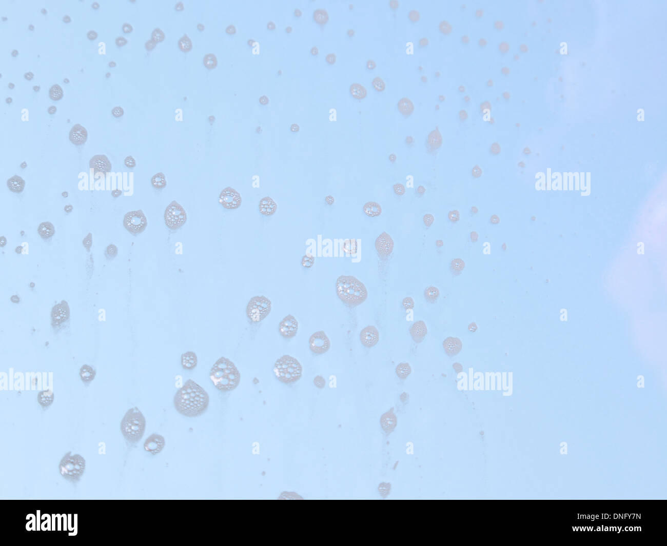 Drops on the windowpane, cleaning window with spray detergent. Glass ...