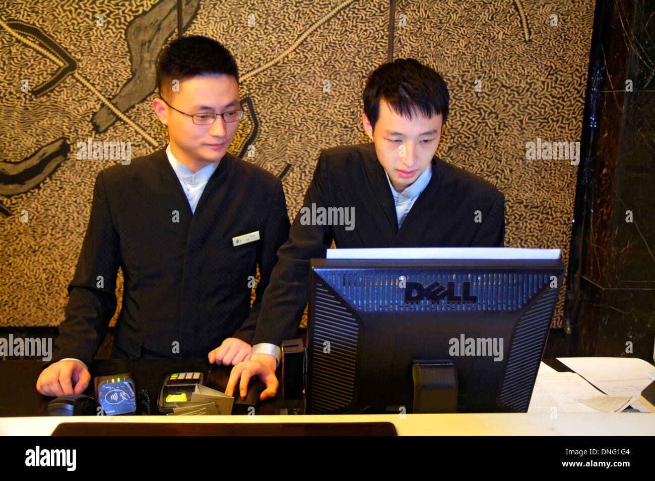 Asian male reception desk hi-res stock photography and images - Alamy