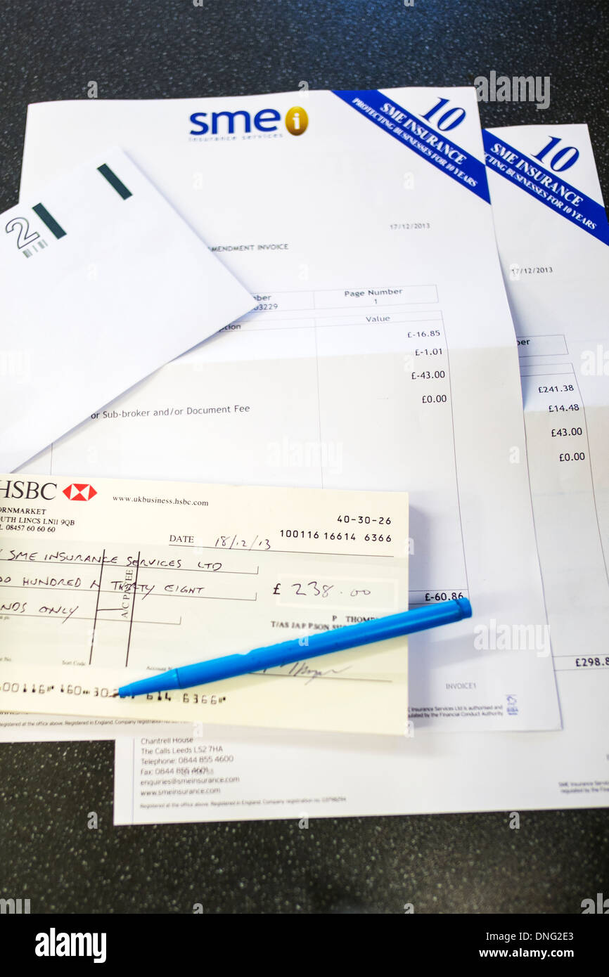 Insurance premium to be paid cheque book payment pen written out SME ...