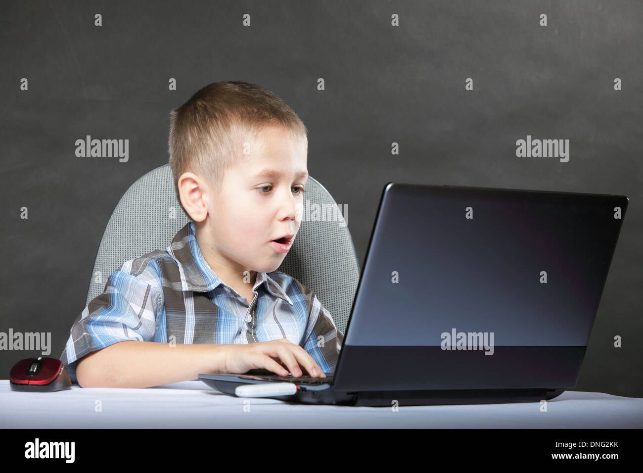 Computer addiction child boy with laptop notebook black background ...