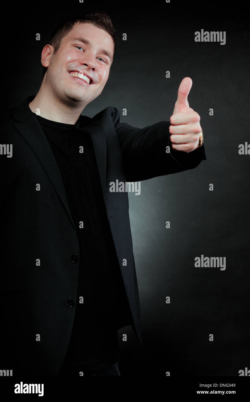 Young man gesturing the ok okay hand sign Stock Photo - Alamy