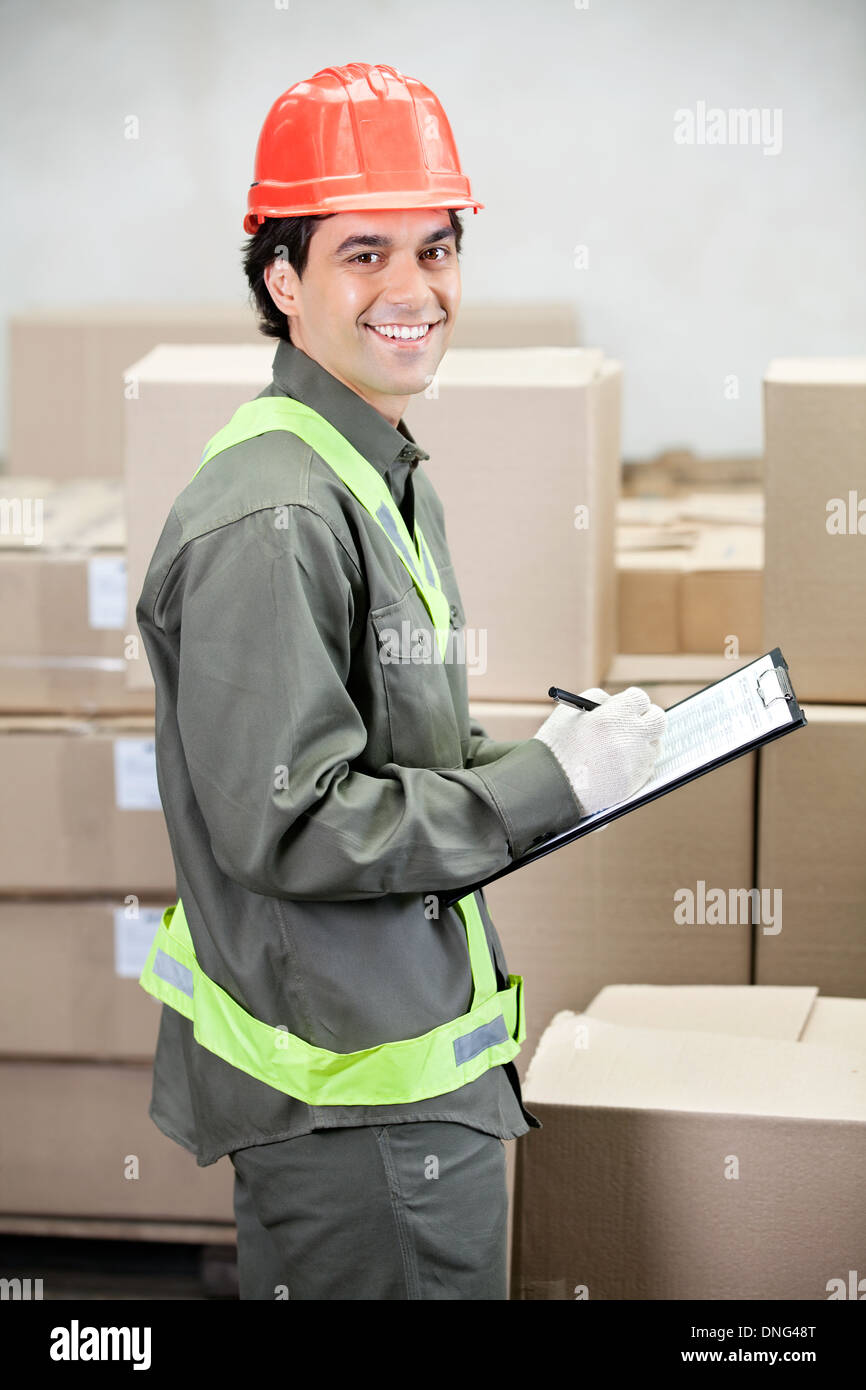 Supervisor Writing Notes At Warehouse Stock Photo - Alamy