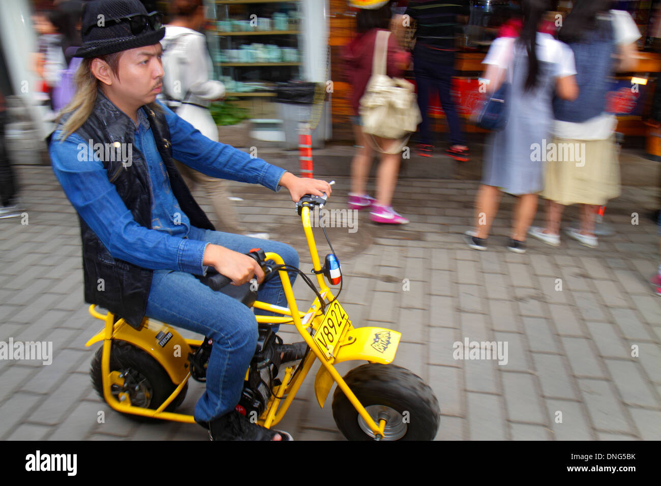 Riding motorized scooter hi-res stock photography and images - Alamy