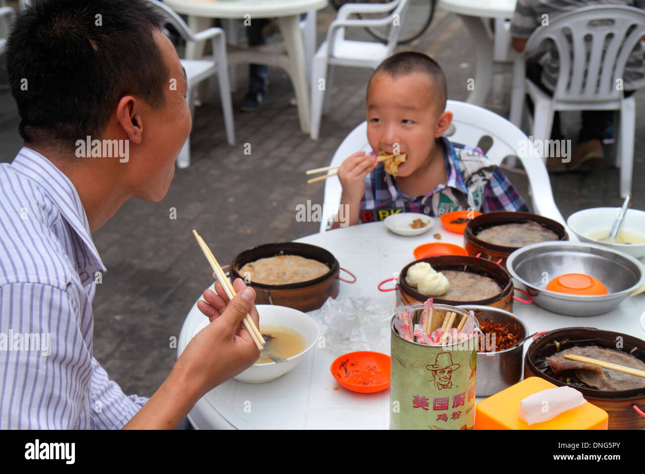 China boy eating with hi-res stock photography and images - Alamy