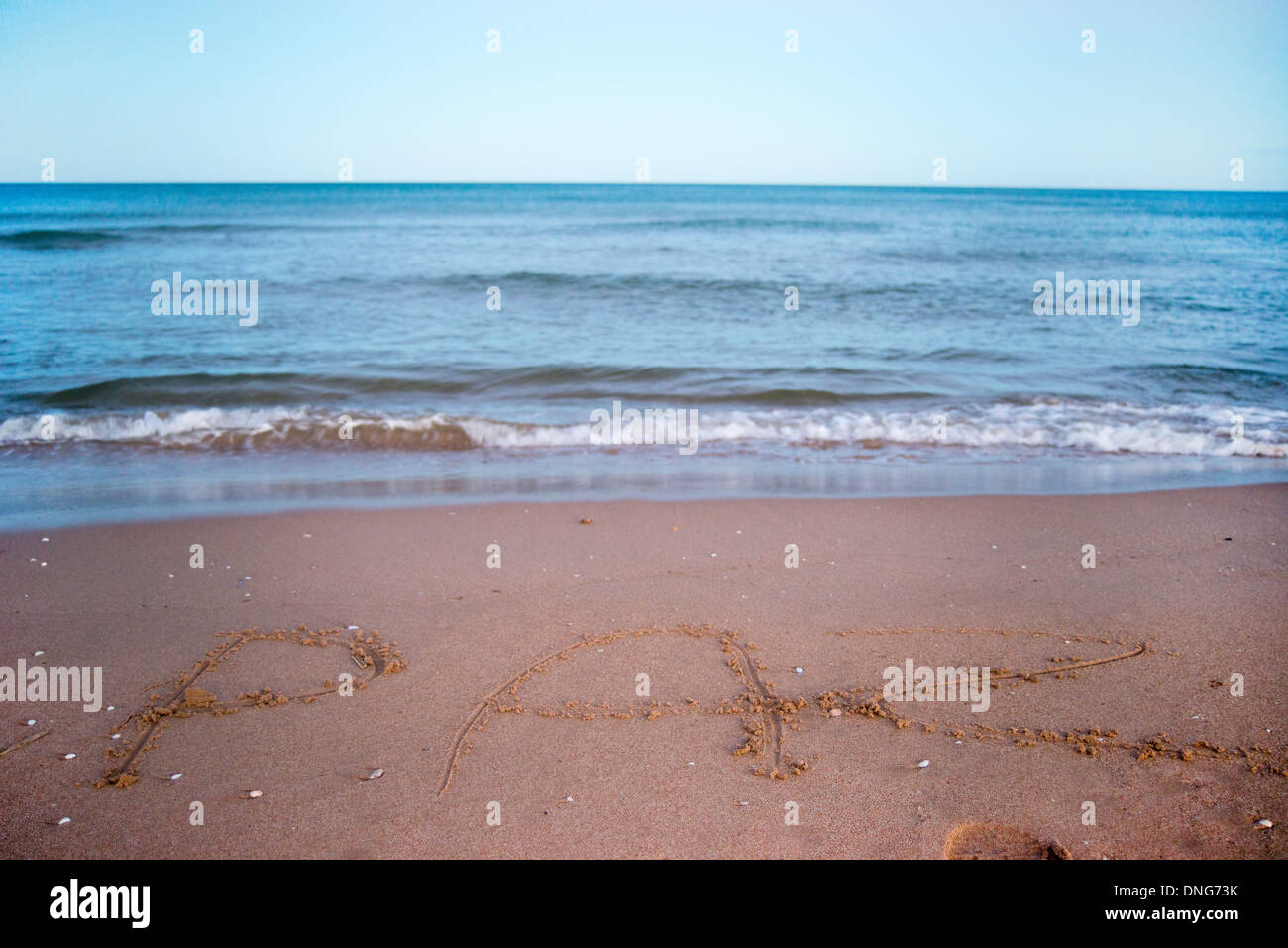 Word peace written in the sand Stock Photo - Alamy