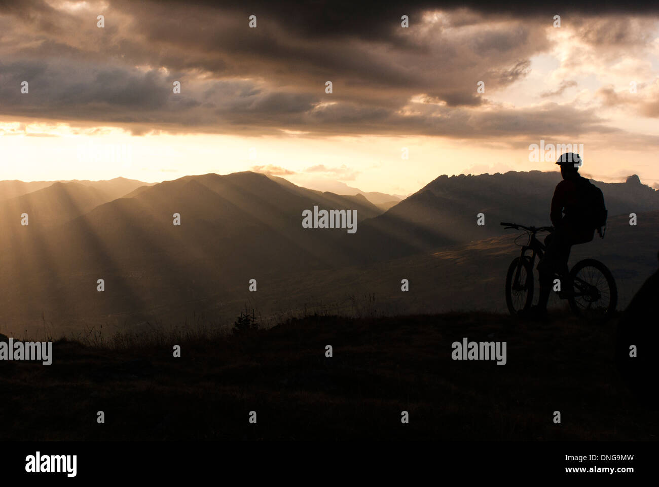 Mountain biker enjoying sunset view. French Alps, Rhône-Alpes, Savoie ...