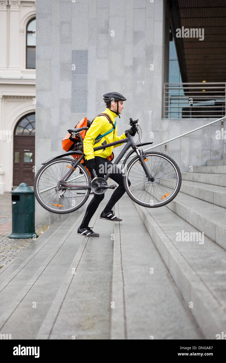 Courier Delivery Man With Bicycle And Backpack Walking Up Steps Stock ...