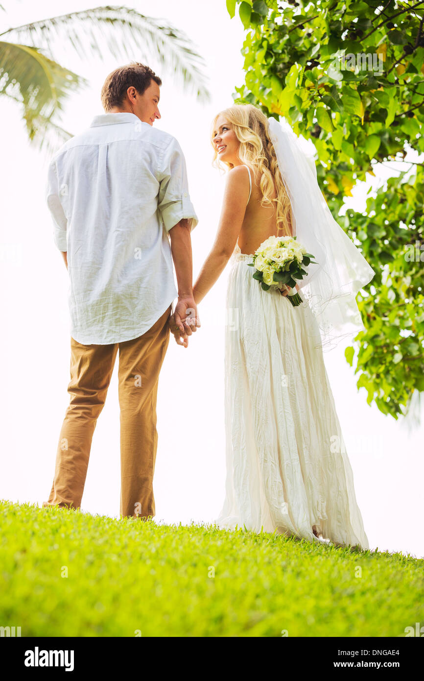Just married couple holding hands, Intimate loving moment at wedding ...