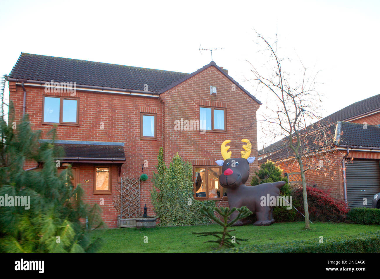 Family house with large reindeer inflatable xmas decorations in front ...