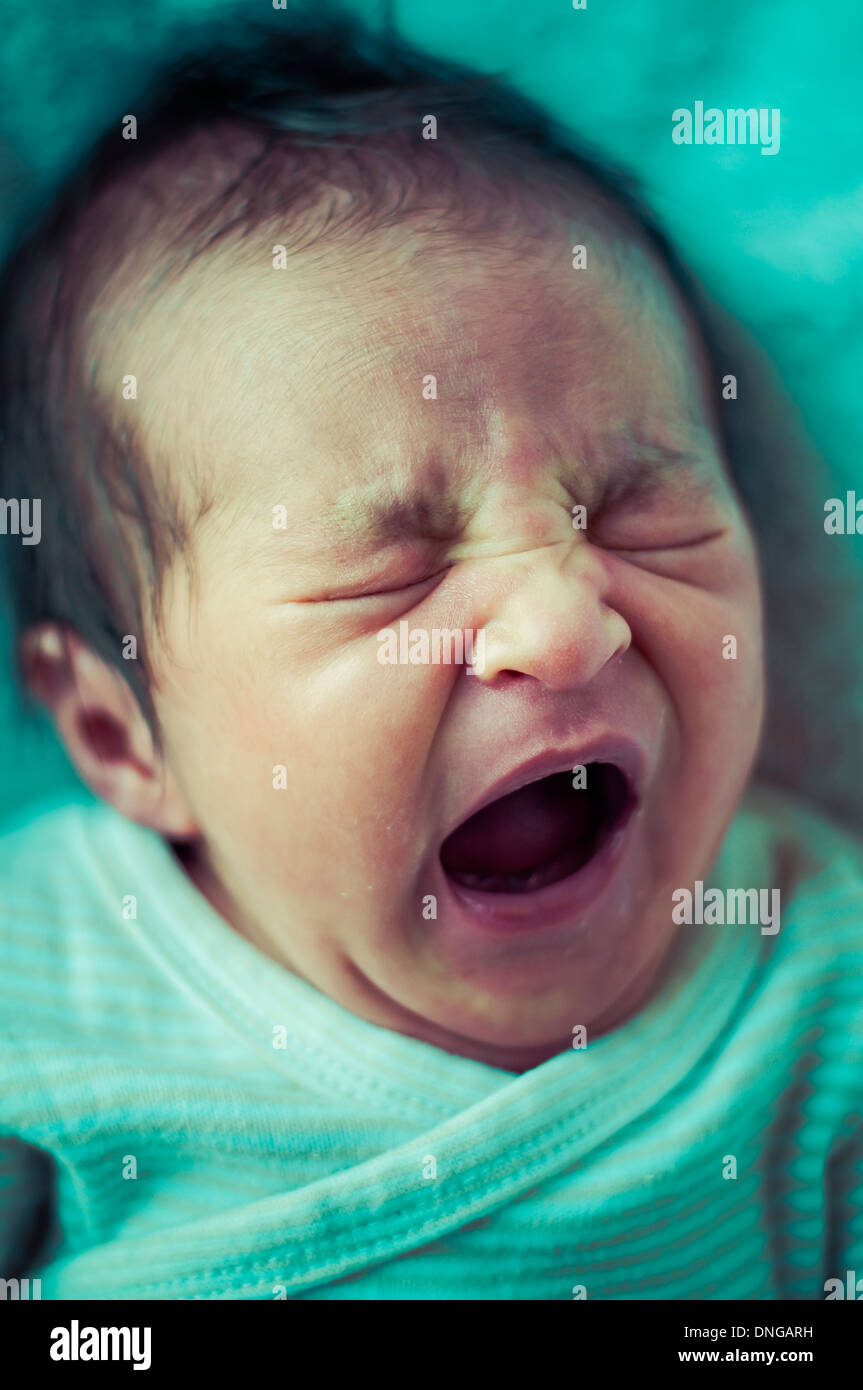 Newborn peacefully sleeping, picture of a baby curled up sleeping on a ...