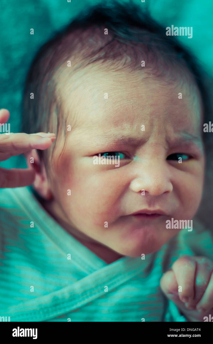 Newborn peacefully sleeping, picture of a baby curled up sleeping on a ...
