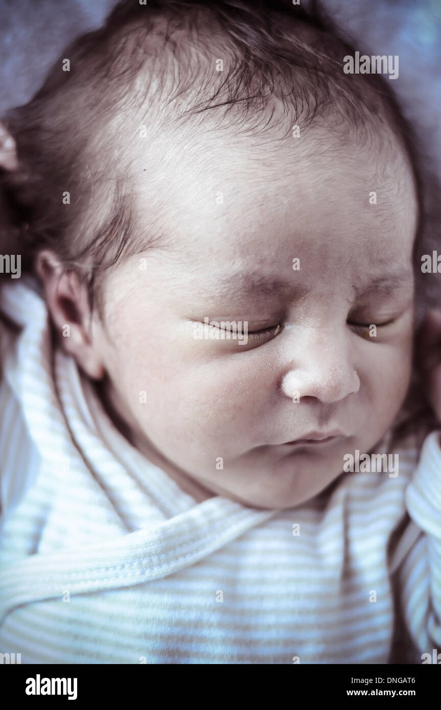 Adorable,new born baby curled up sleeping on a blanket, multiple ...