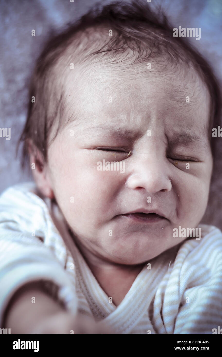 new born baby curled up sleeping on a blanket, multiple expressions ...