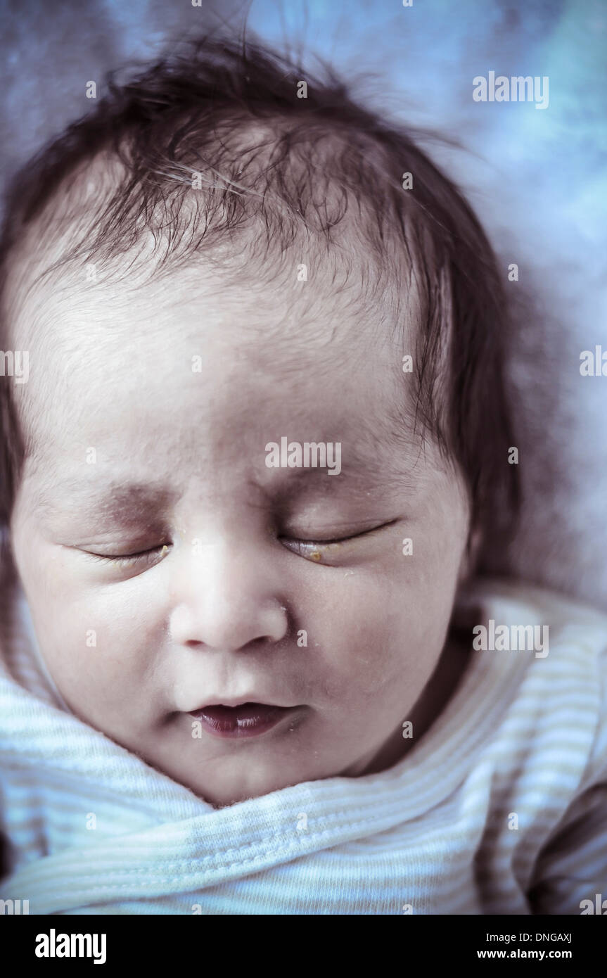 Innocence, new born baby curled up sleeping on a blanket, multiple ...