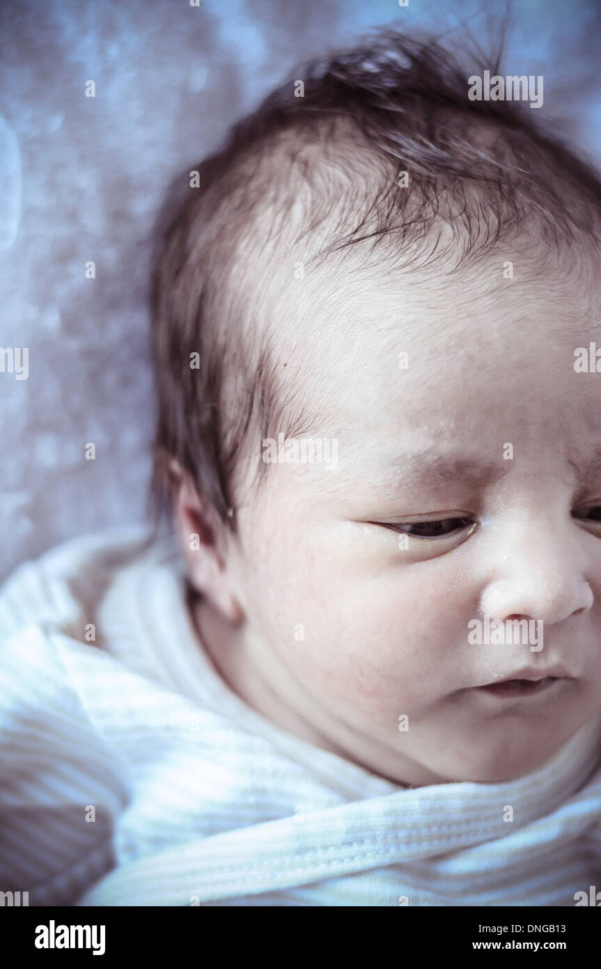 new born baby curled up sleeping on a blanket, multiple expressions ...