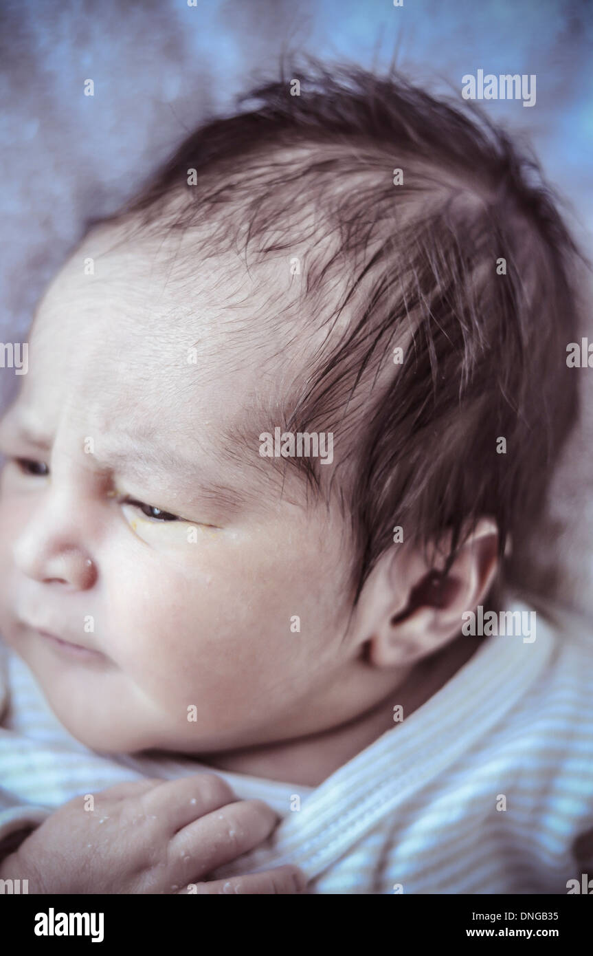 new born baby curled up sleeping on a blanket, multiple expressions ...