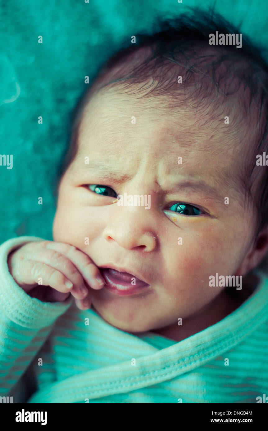 Newborn peacefully sleeping, picture of a baby curled up sleeping on a ...