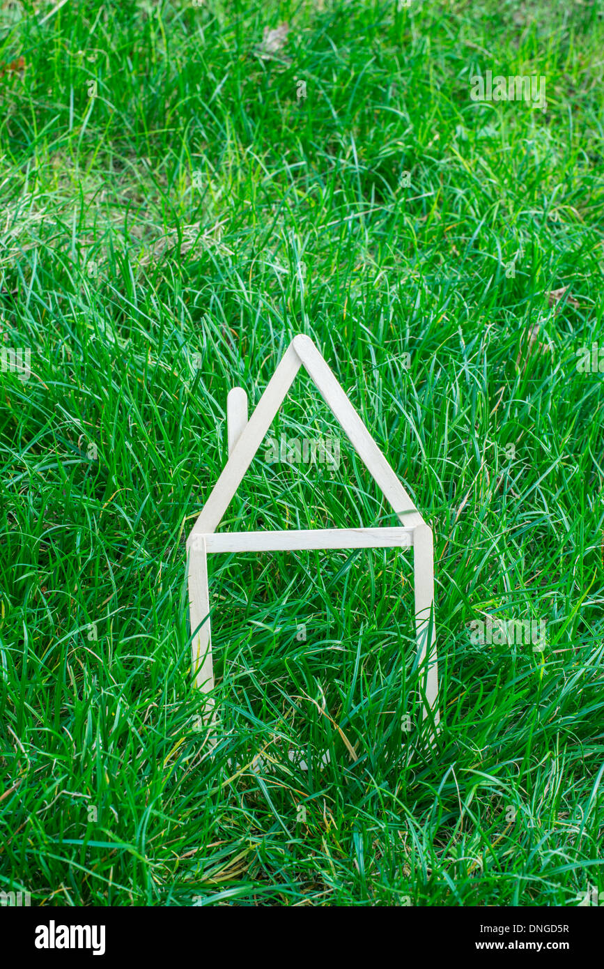 Model house made of wooden sticks on green grass Stock Photo - Alamy