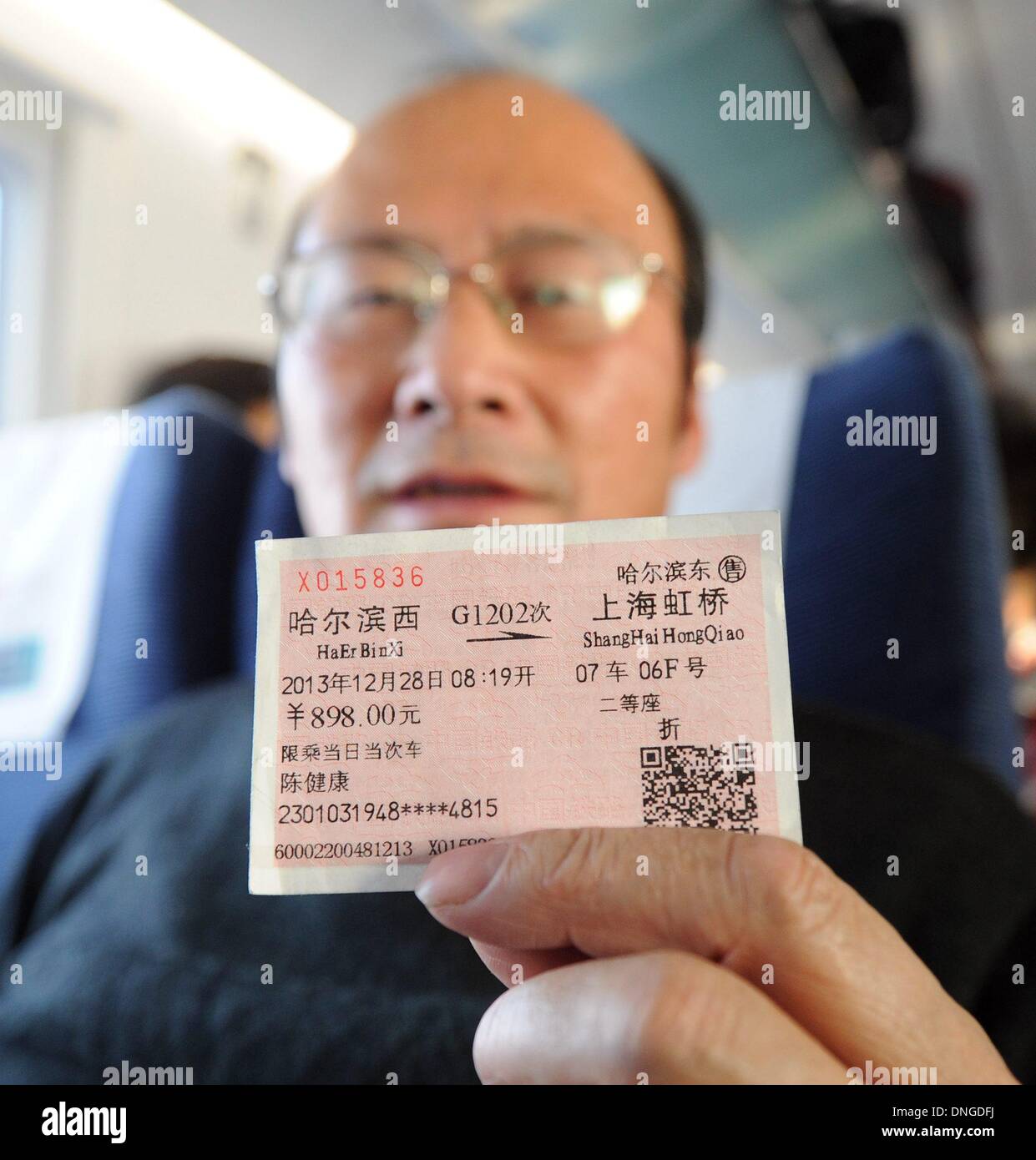 Harbin, China's Shanghai. 28th Dec, 2013. A passenger shows his ticket ...