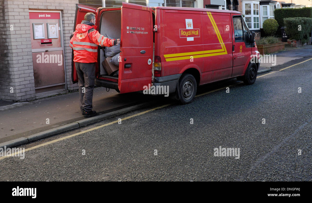 a postman loads hid van with mail after collecting at didsbury post ...