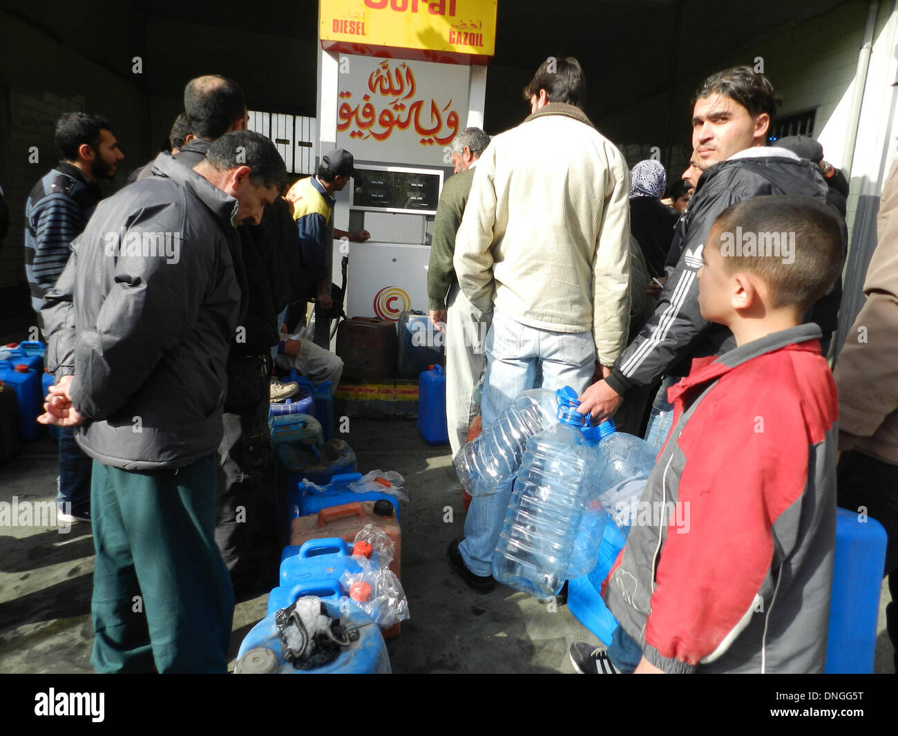 Beirut. 28th Dec, 2013. Syrian refugees get diesel delivered by Lebanon ...