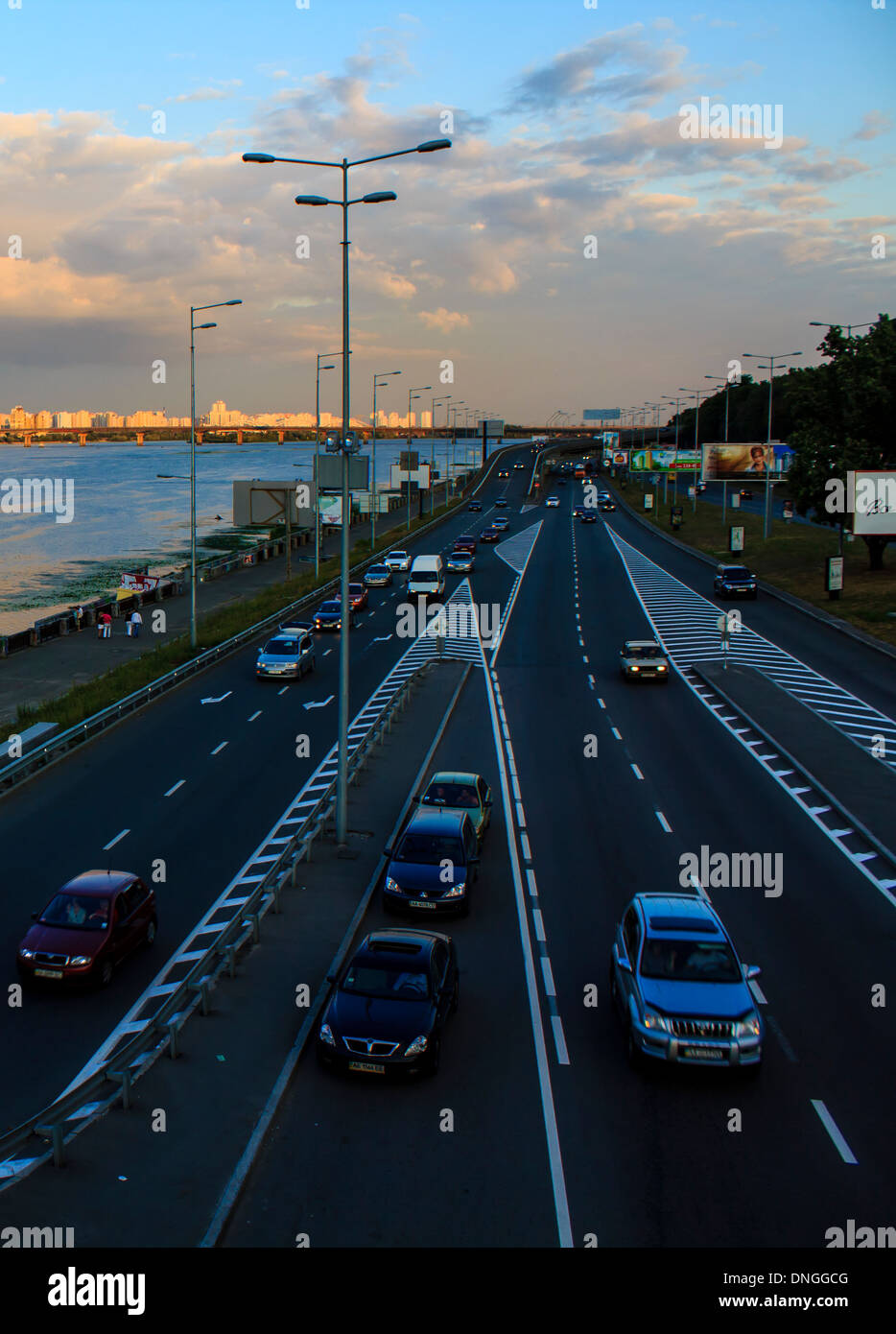 Road with evening traffic by river Dnipro in Kiev, Ukraine. Picture ...