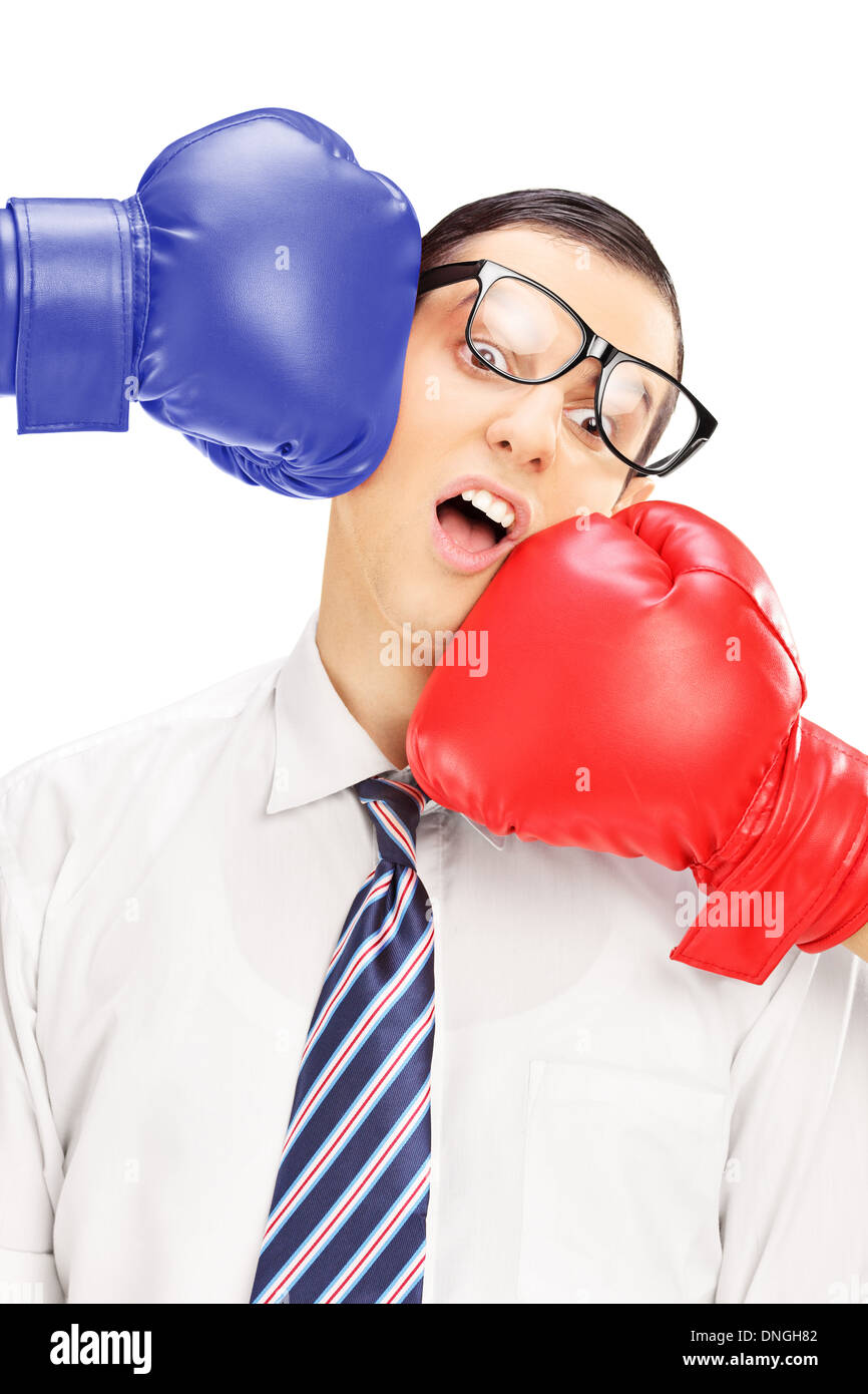 Young man with glasses punched by two boxing gloves isolated on white ...