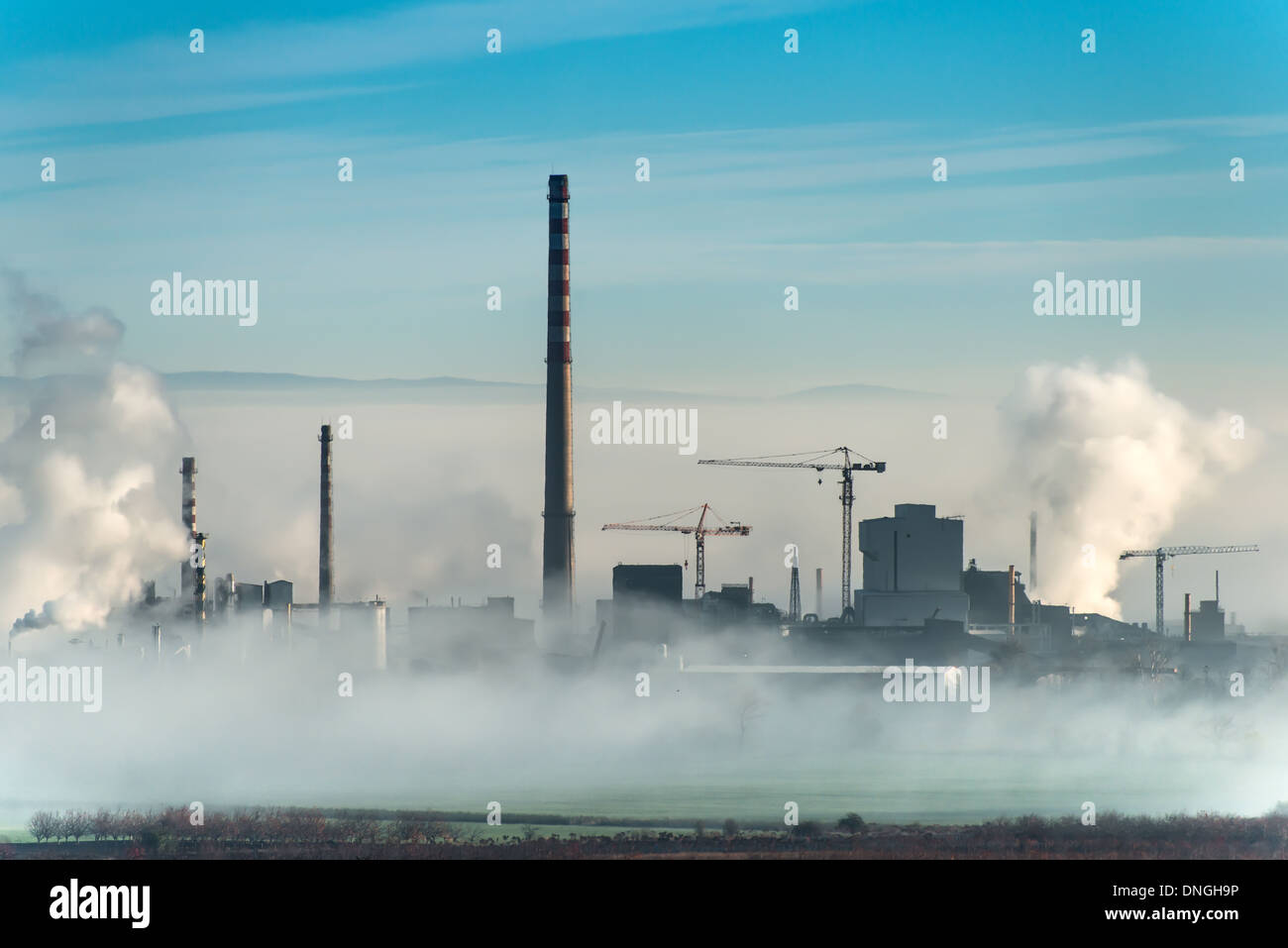 Factory chimneys and clouds of steam.Blue sky Stock Photo - Alamy