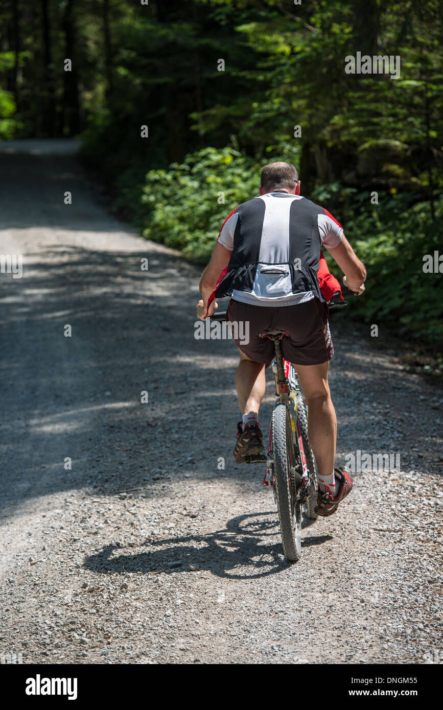 SCHLIERSEE, GERMANY - JULY 13, 2013: An overweight man is riding a ...