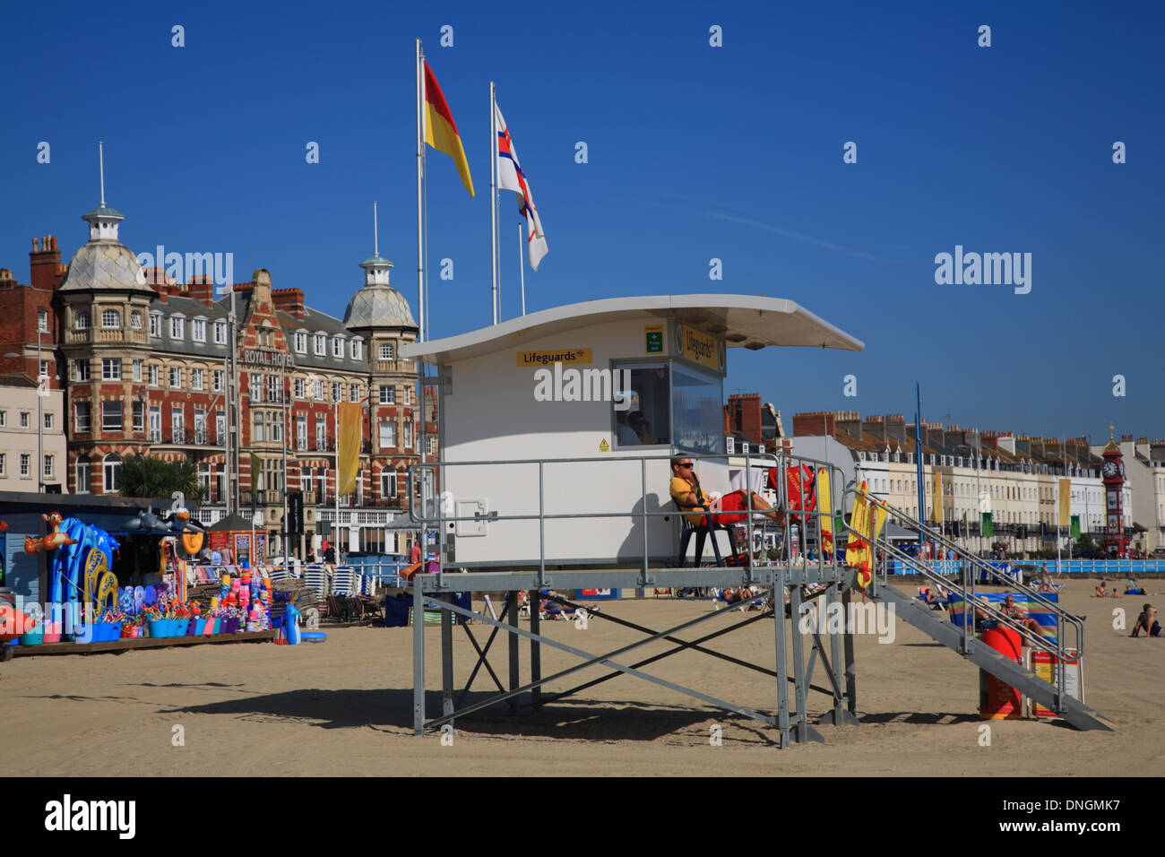 Lifeguard hut with lifeguard on beach in front of the Bay Royal Hotel ...