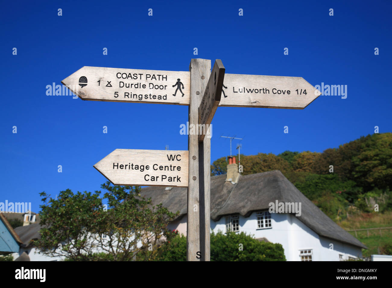 Coastal path sign between Durdle Door and Lulworth Cove with a thatched ...