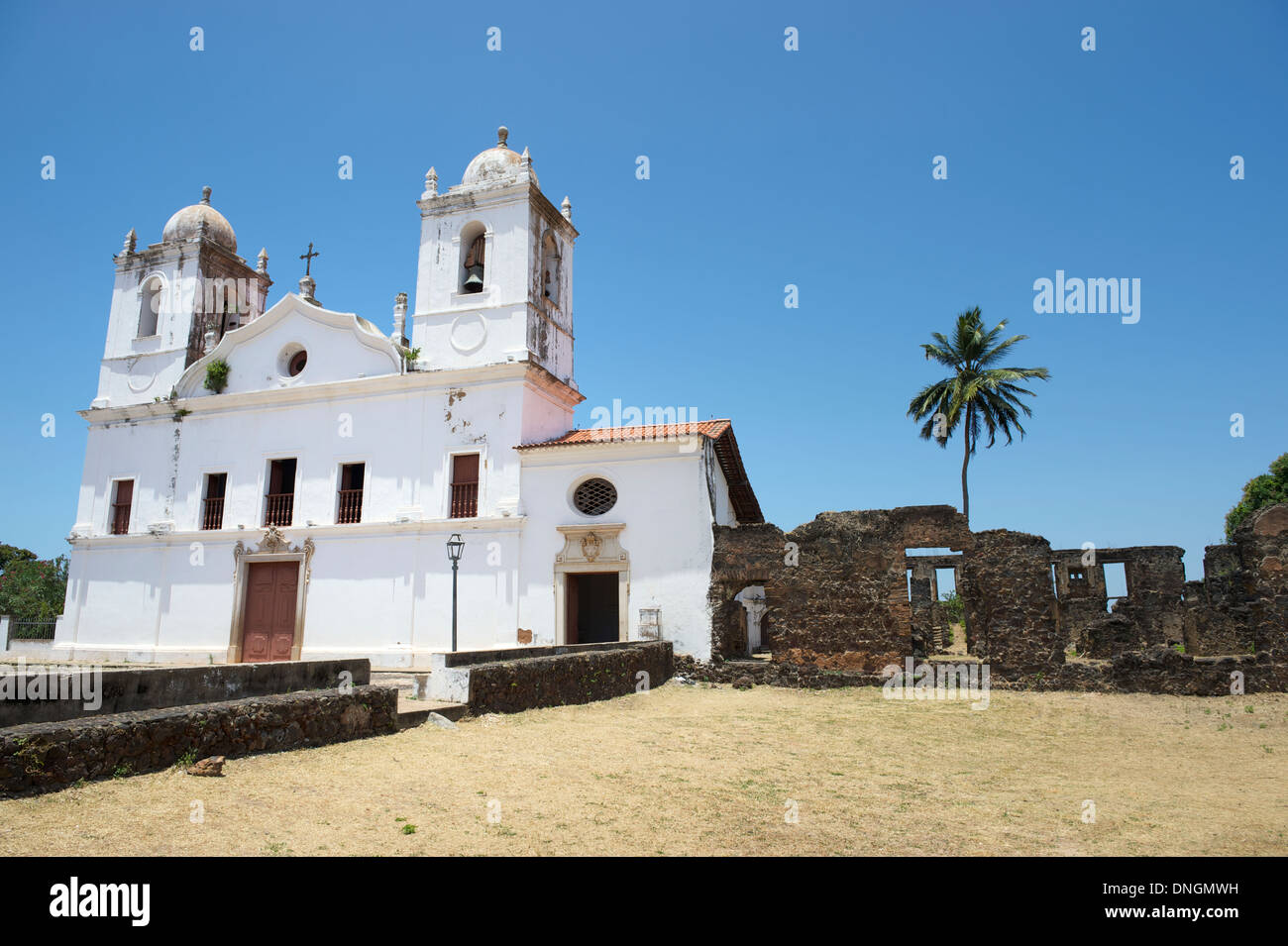 Typical simple white colonial church with stone ruins in Alcantara ...