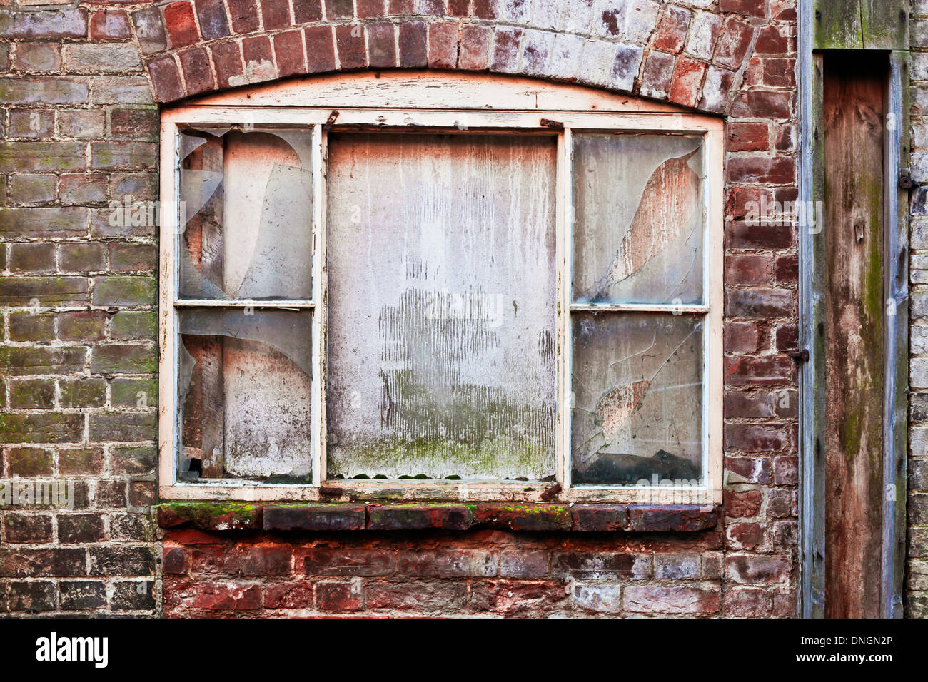 A broken window in a brick wall Stock Photo - Alamy