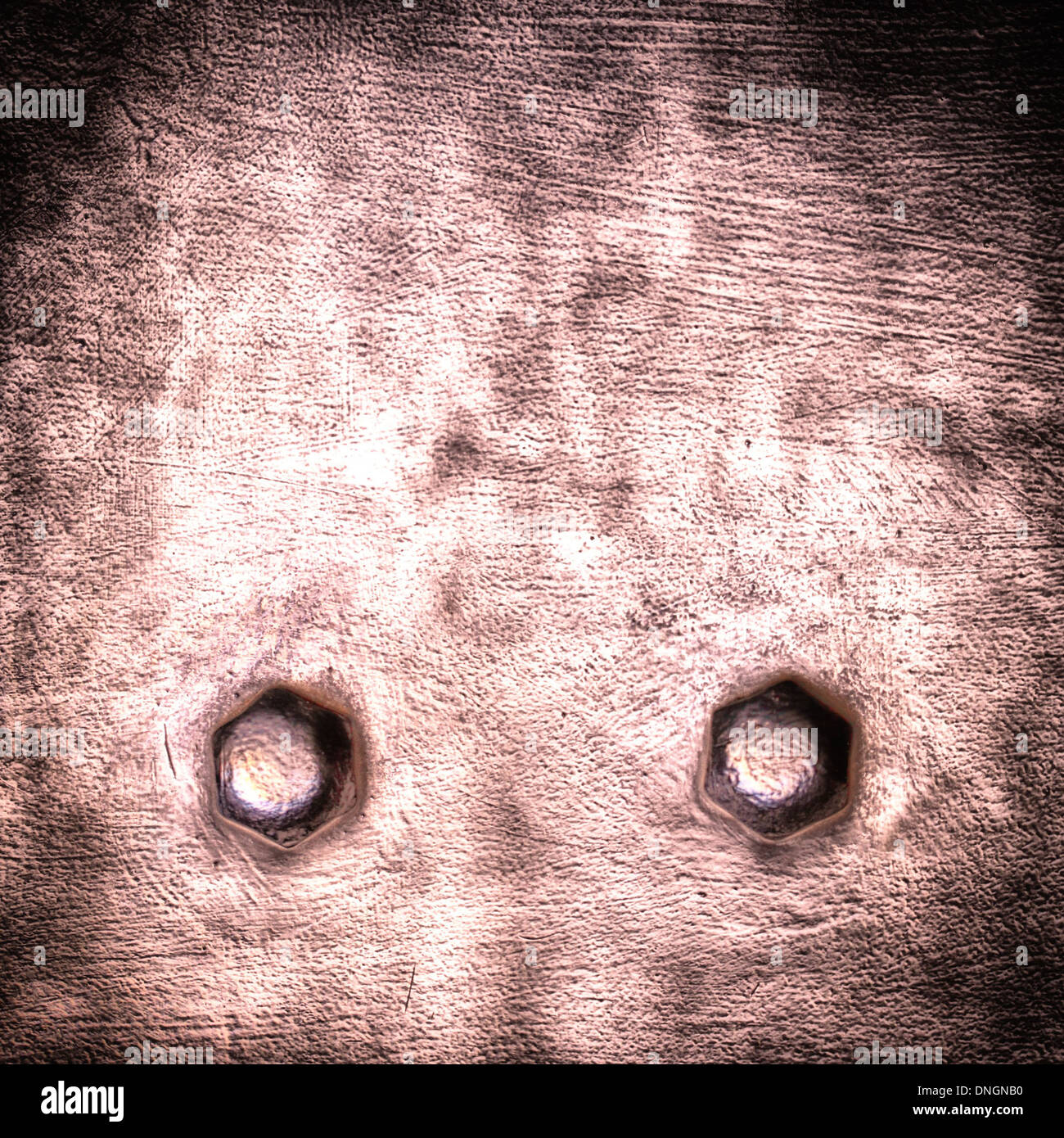 Closeup of grunge red metal plate with rivet screw as background or ...