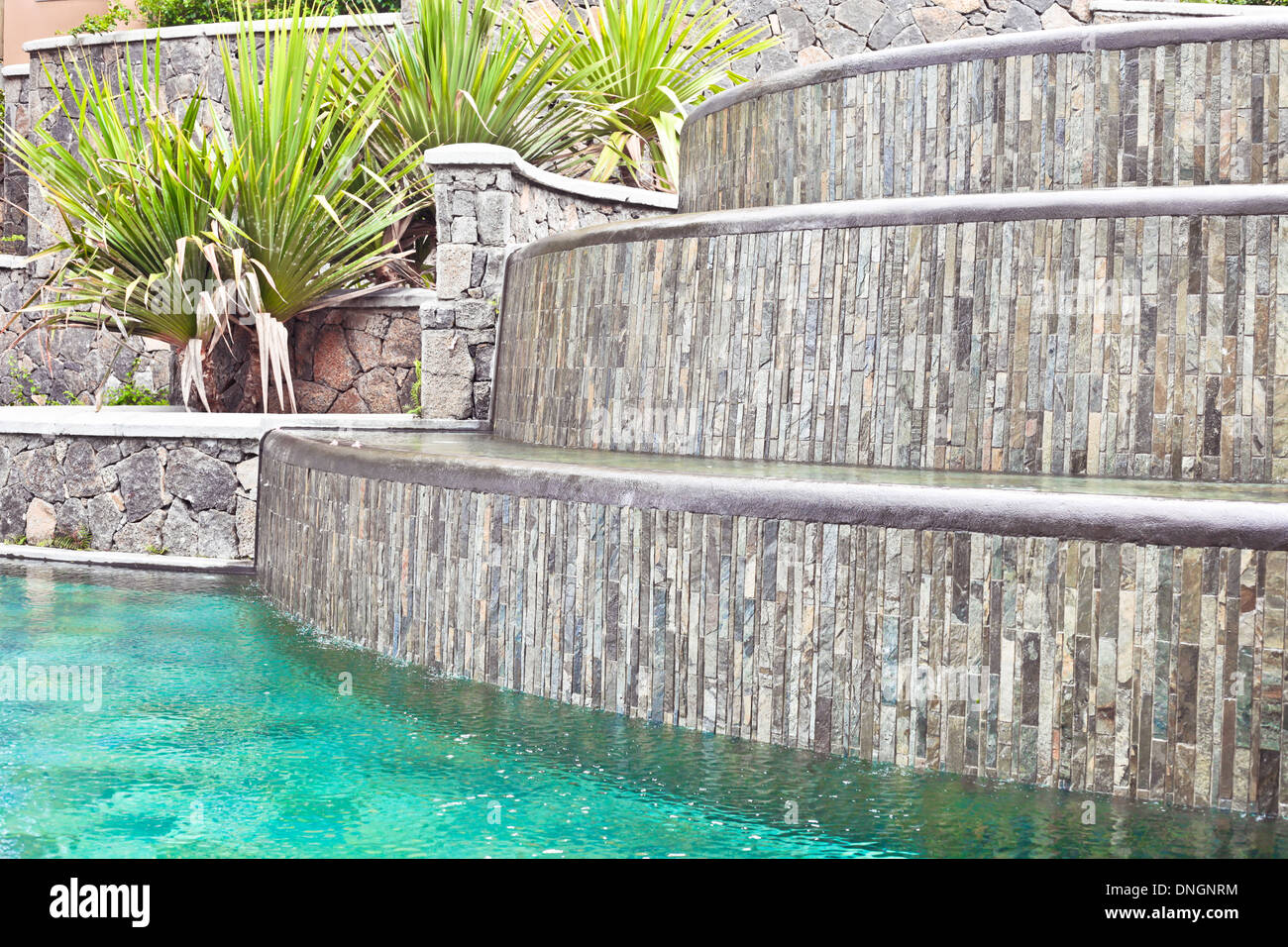 A water feature in a tropical landscaped garden Stock Photo - Alamy
