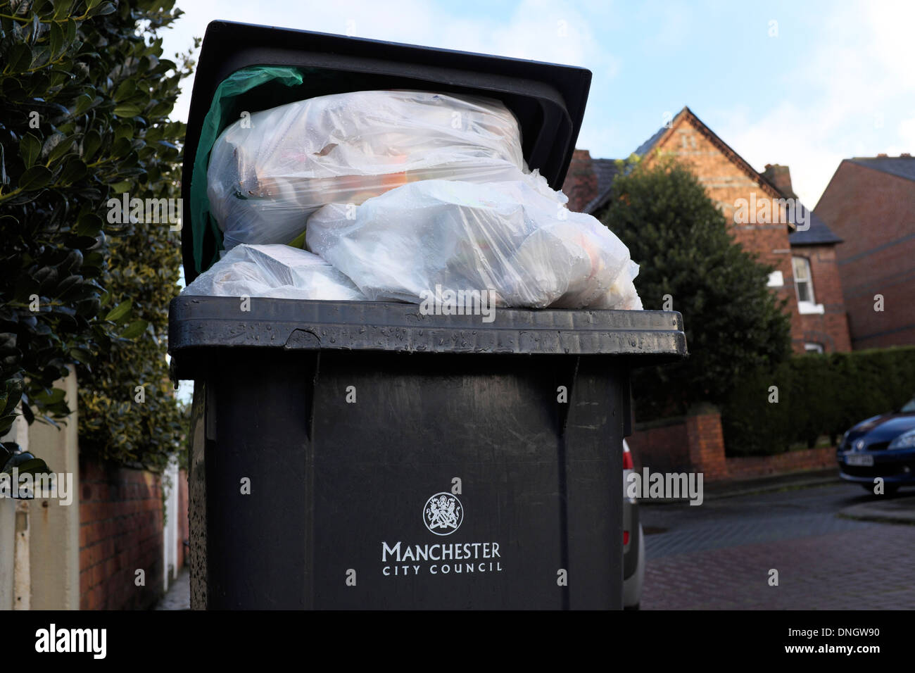 a wheelie bin packed full with waste after christmas Stock Photo - Alamy