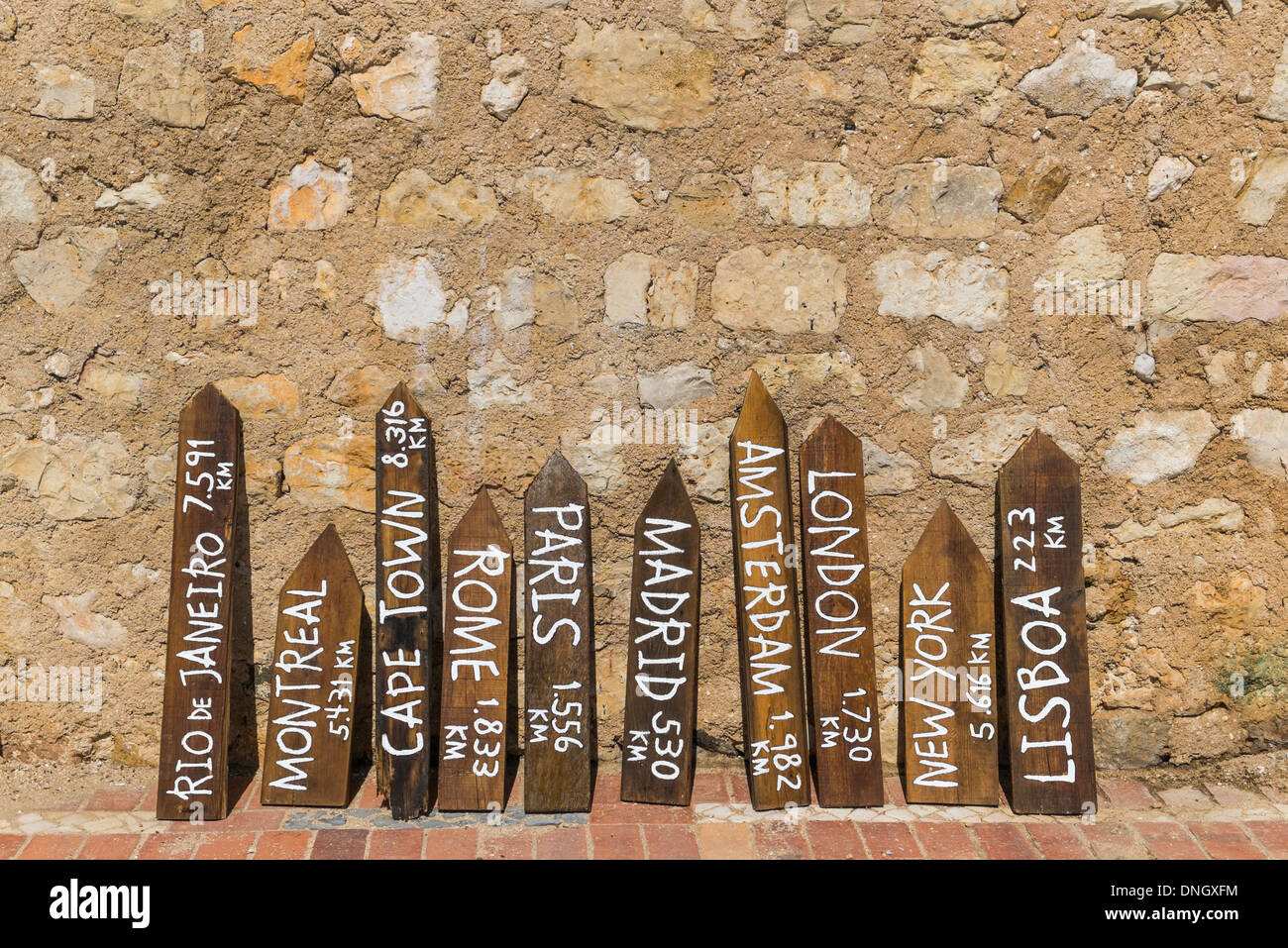 freshly painted distance indicators leaning on a natural stone wall ...