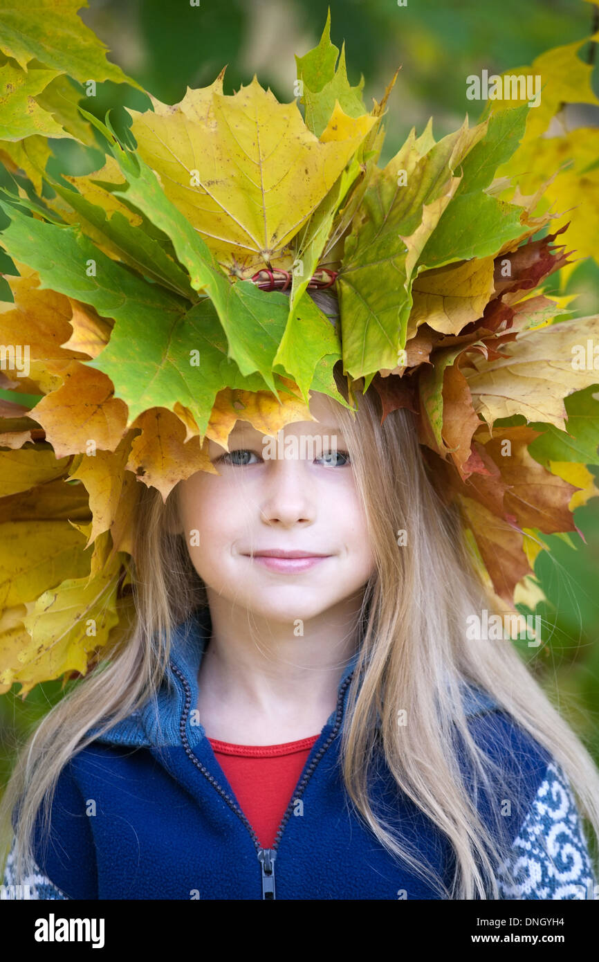 portrait of beautiful caucasian little girl in yellow autumn maple ...