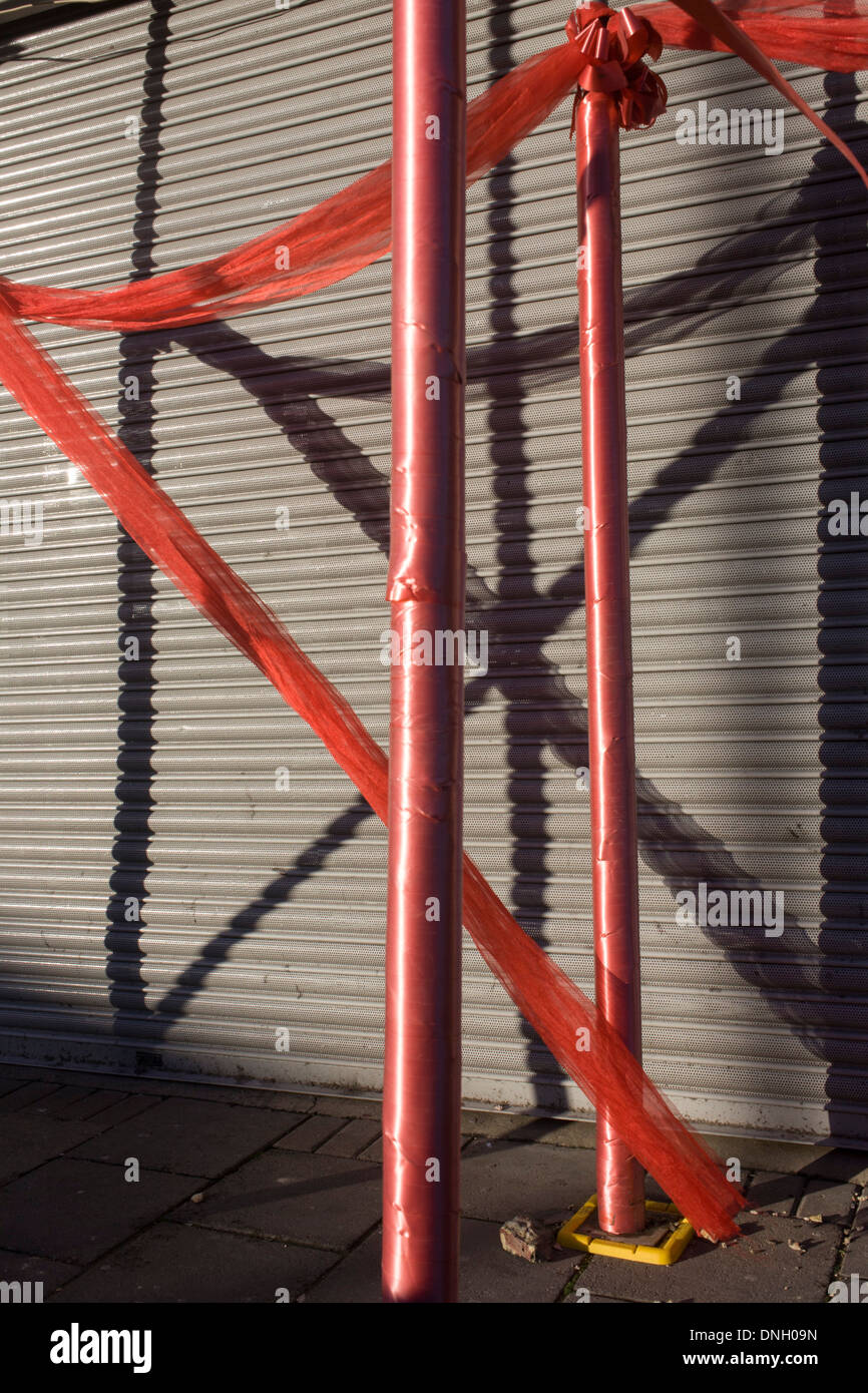Red netting draped across street construction with patterns formed by ...