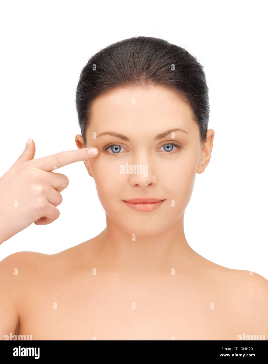 beautiful woman pointing to eye Stock Photo - Alamy