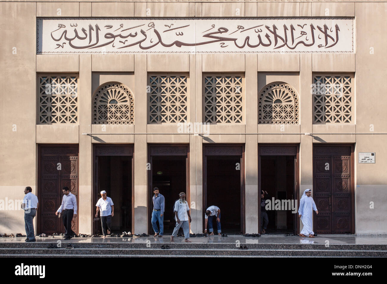 MUSLIM FAITHFUL, SOME IN TRADITIONAL EMIRATE DRESS, LEAVING AFTER ...