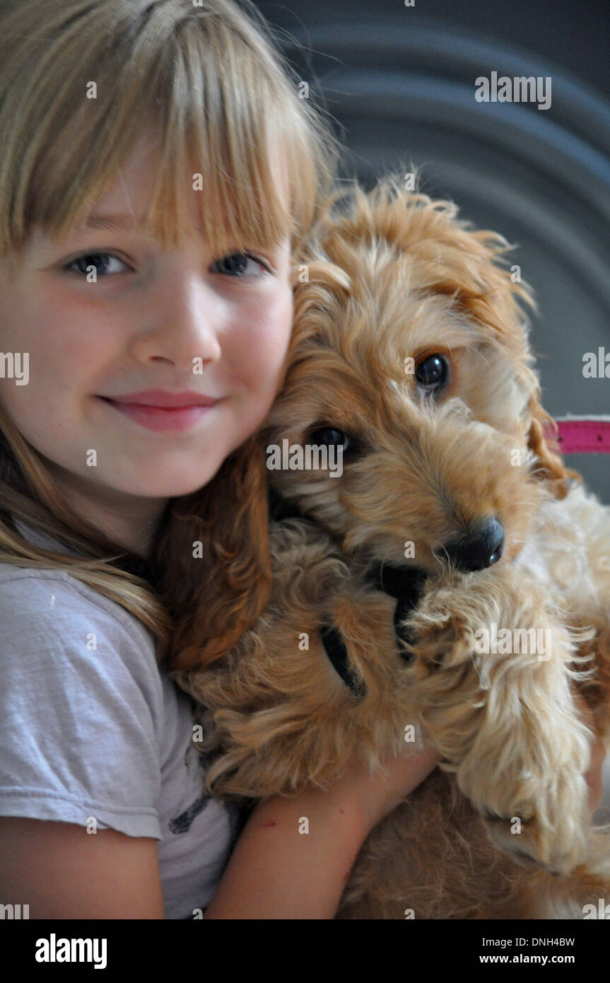 portrait of girl cuddling her puppy dog Stock Photo - Alamy